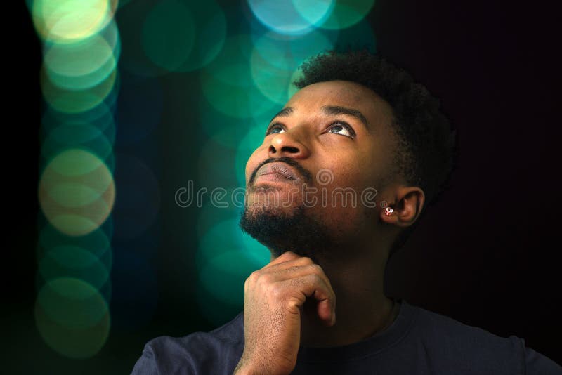 Man Thinking Looking Up on Green Lights Background Stock Photo - Image ...