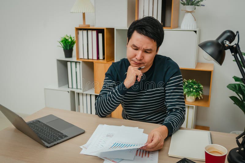 Man Thinking and Planing about Business. Working with Document and Laptop at Home Office Stock ...