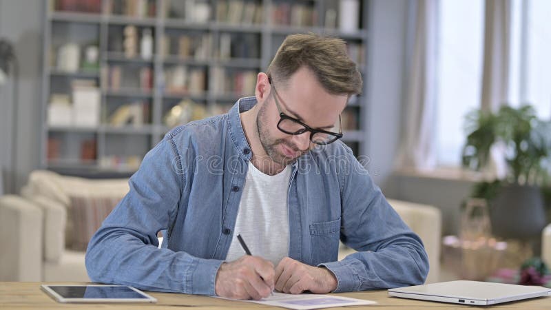 Man Thinking and Writing on Paper in Office Stock Image - Image of ...