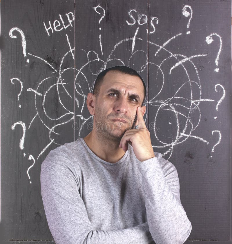 A Man Thinks and Behind Him on the Wall are Painted with Chalk ...