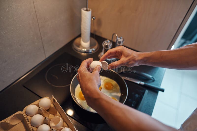 Man Throw Broken Egg on Pan with Other Fried Eggs Stock Image - Image ...