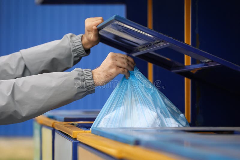 Man Throwing Garbage into Bin at Recycling Point Outdoors, Closeup ...