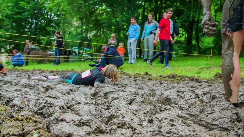 People Crawling through Mud As Part of Obstacle Course Stock Footage ...