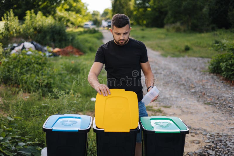 Man Throwing Plastic Bag into Recycling Bin on Back Yard. Different ...