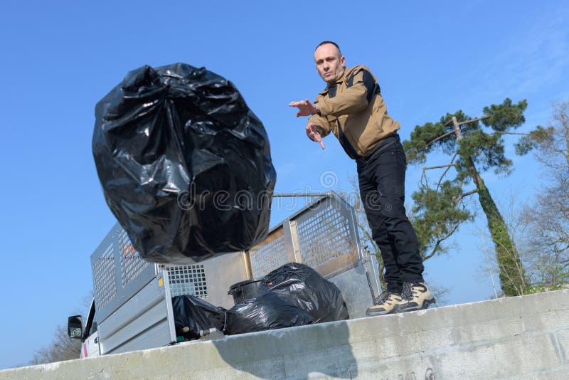 Man throwing refuse bag stock image. Image of tree, dump - 239075343