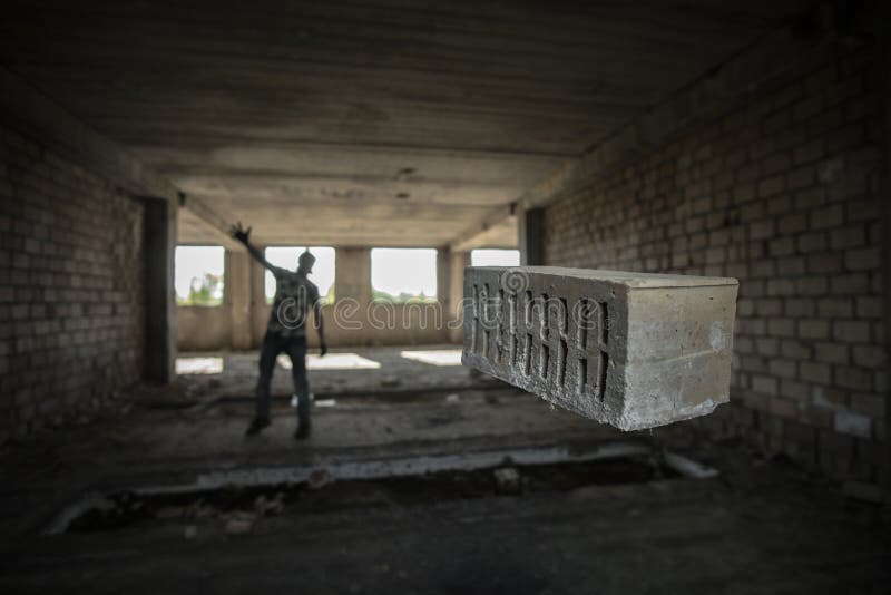 A Man Throws a Brick Flying into the Camera. Stock Image - Image of ...