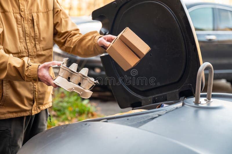 Man Throws Cardboard Garbage into Recycling Bin Outside Stock Image ...