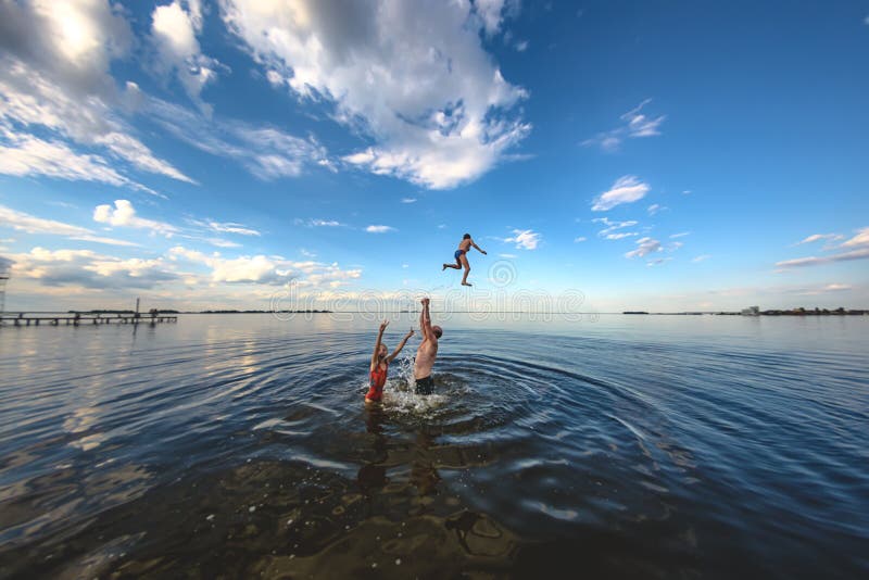 A Man Throws the Child Up in the Water Stock Image - Image of throw ...