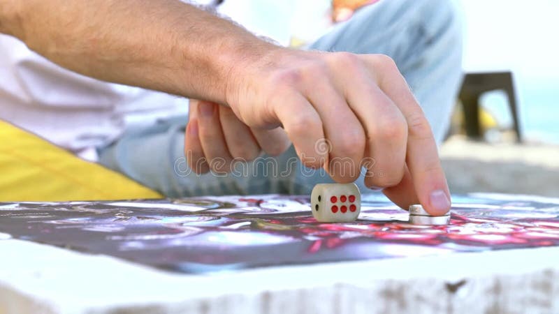 Man Throws Dice and Makes Move with Chip in Board Game, Outdoors, Hands ...