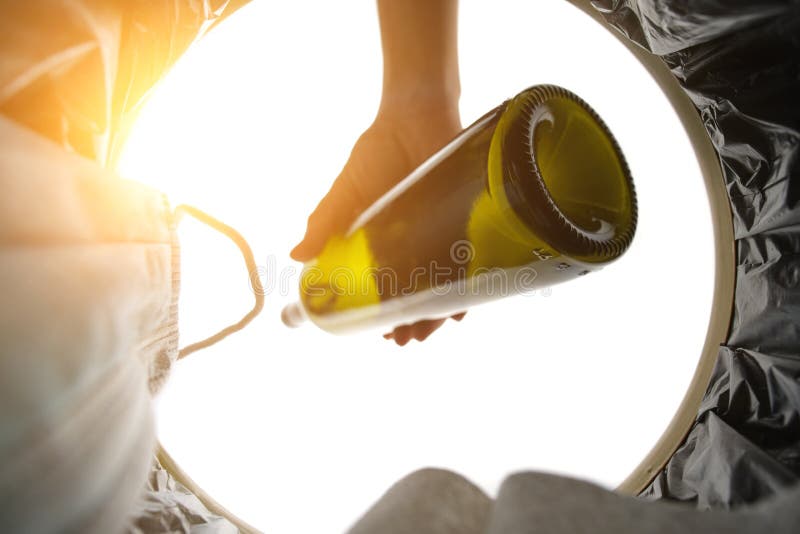 Man Throws an Empty Glass Wine Bottle into Trash.View from Inside with ...