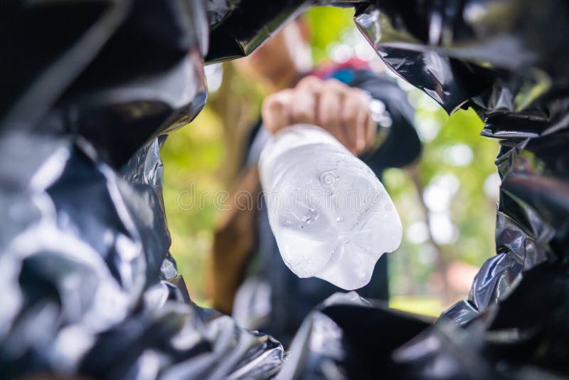 Man Throws Garbage into a Garbage Can on the Street. with a Worm View ...