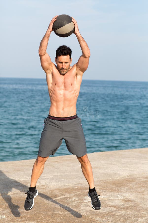 Man throws medicine ball stock photo. Image of increase - 89405932