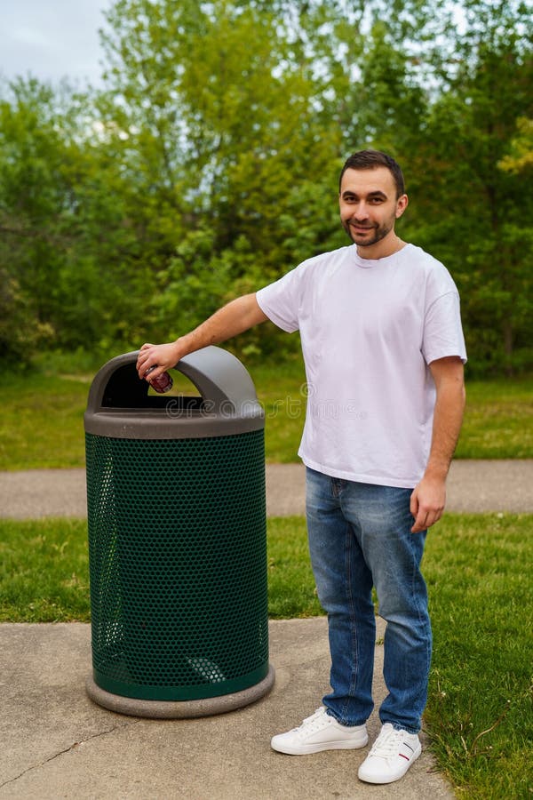 A Man Throws a Trash into the Bin. Utilization of Waste on the Street ...
