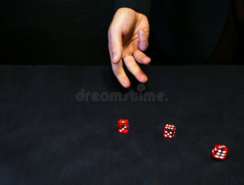 Man Throws Red Dice On A Black Table Surface, Casino Concept Stock ...