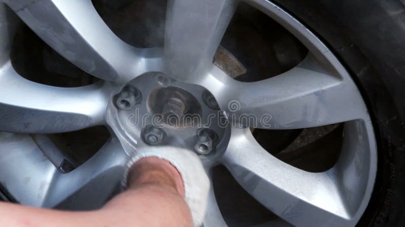 Man Tight Nuts on Car Wheel by Automatic Stock Footage - Video of ...