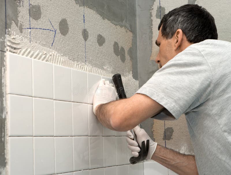 Man Tiling a Wall stock image. Image of sheet, mortar - 11572791