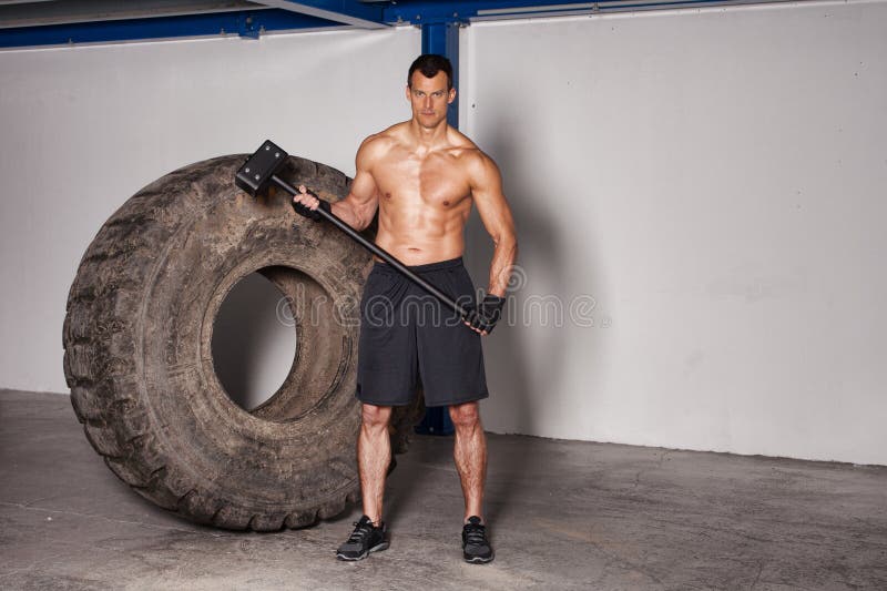 Man with Tire and Hammer Crossfit Stock Image - Image of muscular ...