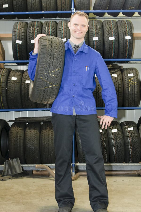 Man in the Tire Store with a Tire Stock Image - Image of looking, adult ...