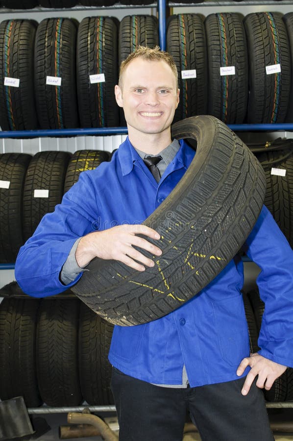 Man in the Tire Store with a Tire Stock Photo - Image of shop, check ...