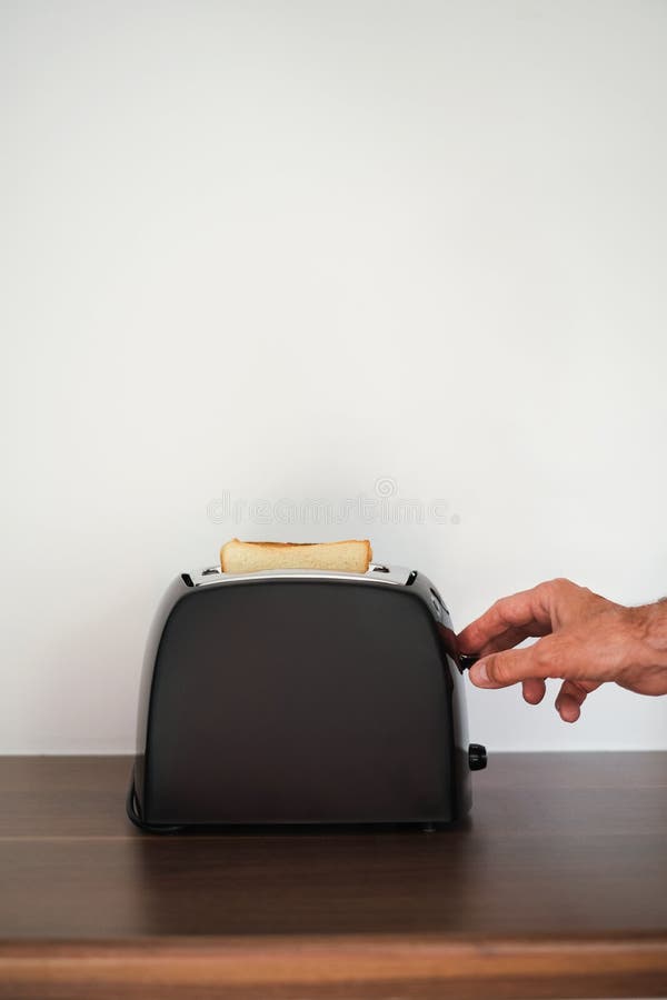 Man Preparing Toast for Breakfast in a Toaster Stock Photo - Image of ...