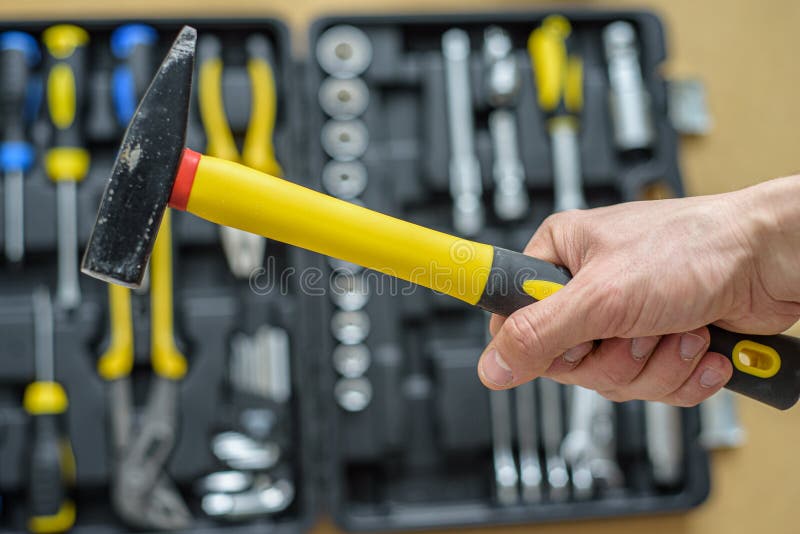 A Man Took a Hammer from a Case with Tools for Work. Stock Image ...
