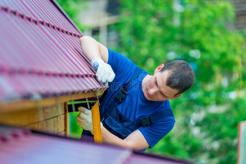 A Man with a Tool during the Repair of the Roof Stock Photo - Image of ...