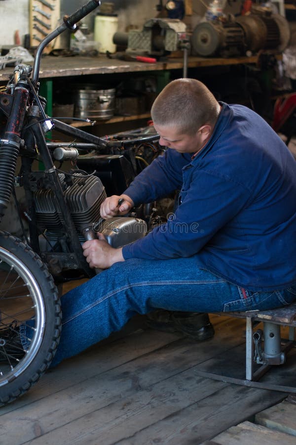 Man with Tools Repairing Old Motorcycle in Workshop Stock Image - Image ...
