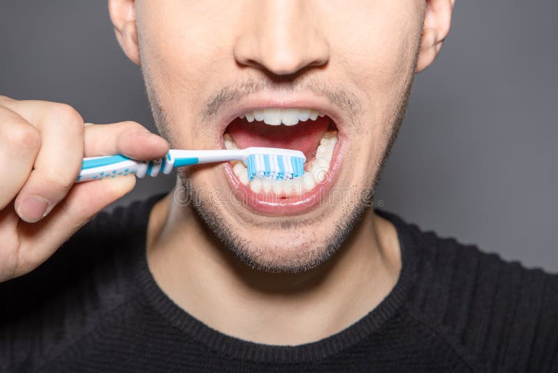 Man with Toothbrush on Back of His Bottom Teeth Brushes the Rear ...