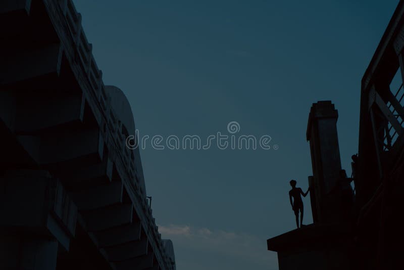 Man on Top of the Building during Night Time Stock Photo - Image of ...