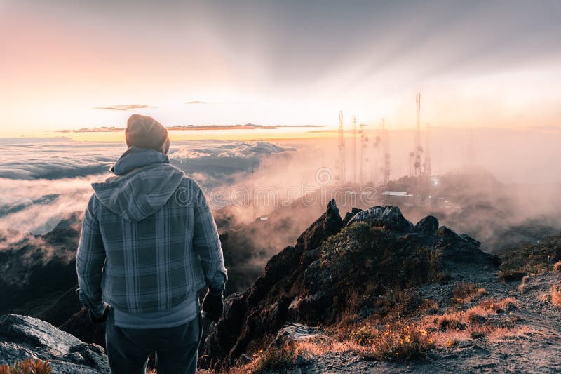 Man on Top of a Mountain Gazing the Cloudy Views Stock Photo - Image of ...