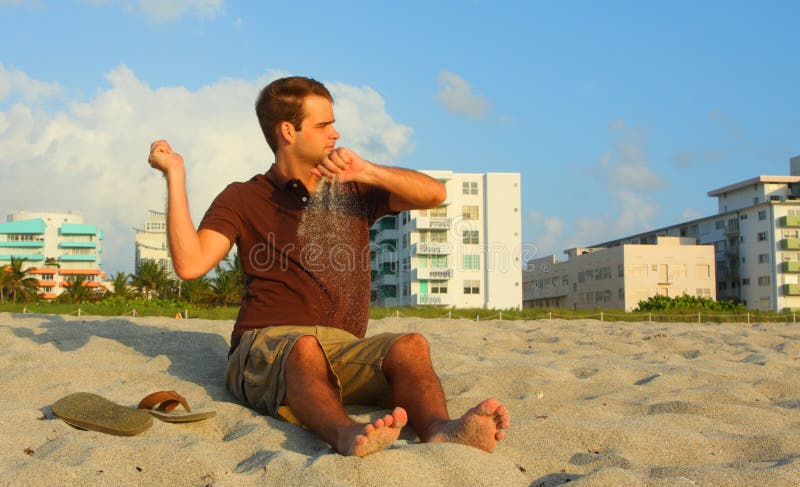 Man Tossing Sand Picture. Image: 5087048