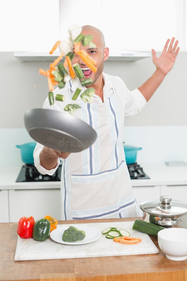 Cheerful Man Tossing Vegetables in Kitchen Stock Image - Image of ...