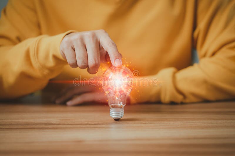 Man Touching a Bright Light Bulb. Ideas for Presenting New Ideas ...