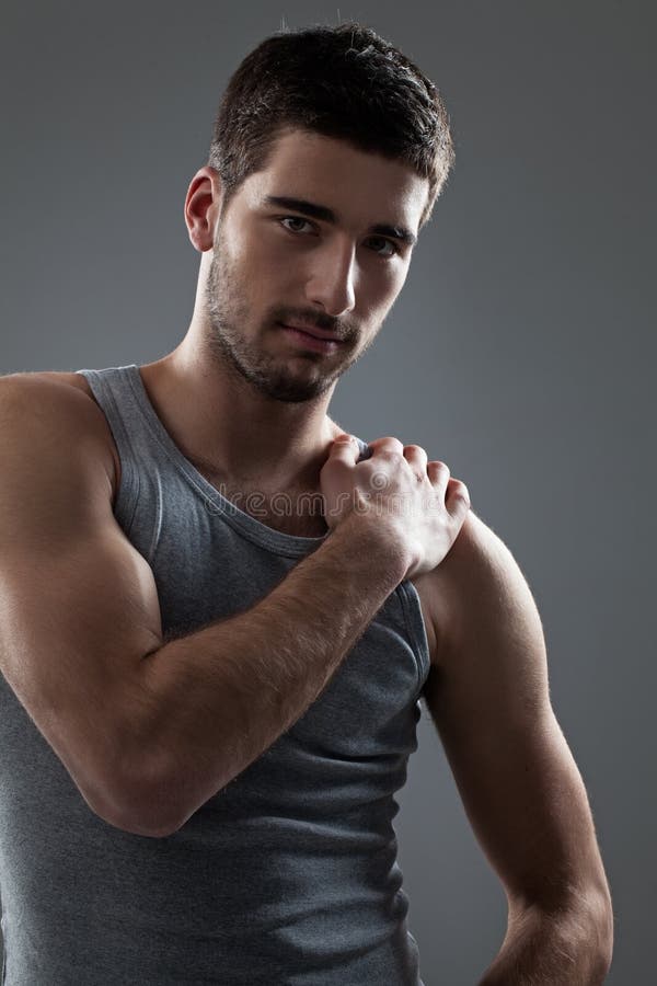 Man Touching His Shoulder stock photo. Image of shoulder - 34866990