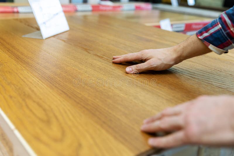 Man Touching Wood Texture of Laminate Floor Sample in Flooring Shop ...