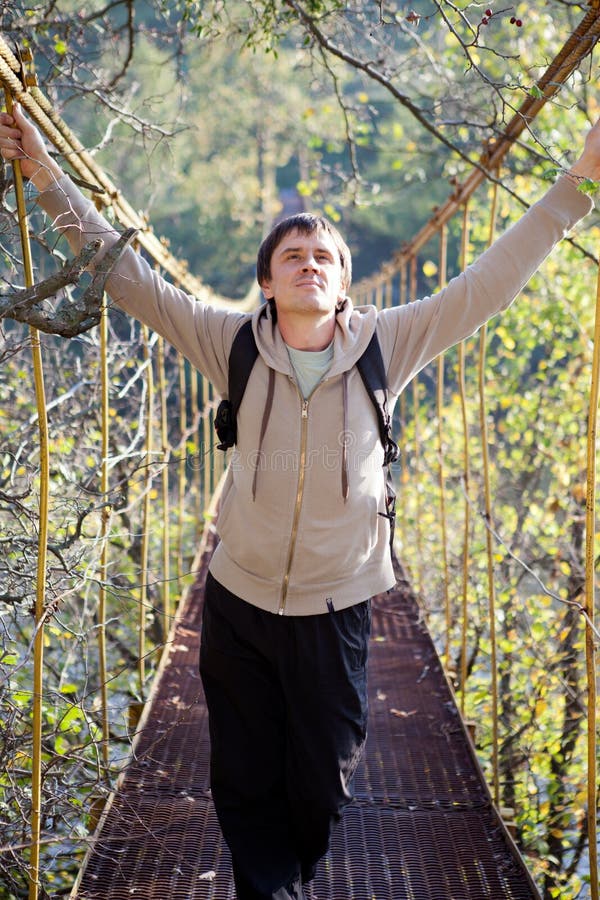 Man Tourist on a Suspension Bridge Enjoys Evening Stock Image - Image ...