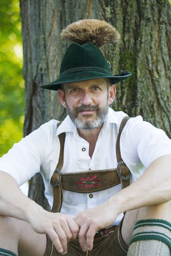 Man in Traditional Bavarian Clothes Sitting by a Tree Stock Image ...