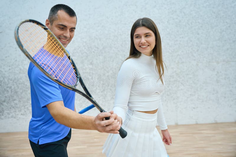 Man Trainer Enthusiastically Demonstrates Action of Hitting Ball in ...