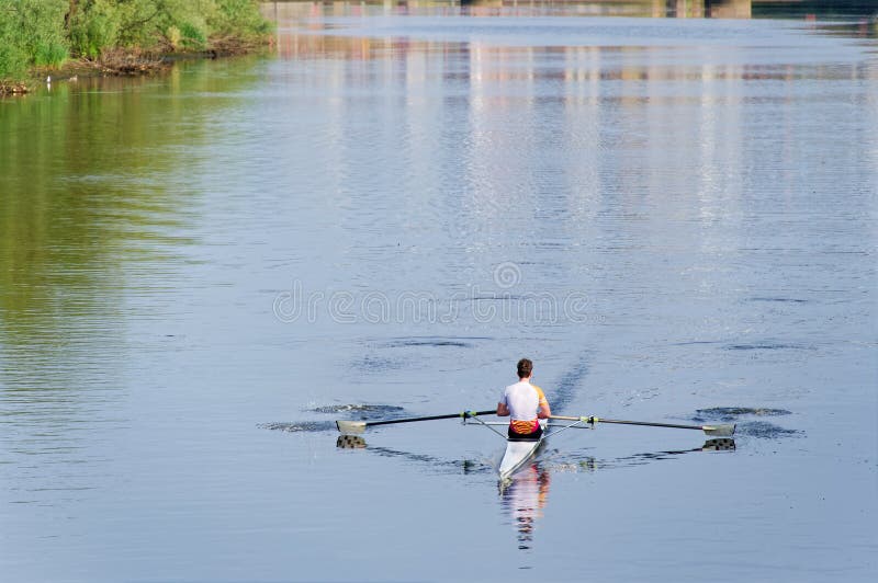 Man Training on Canoe To Practise Rowing during Early Morning on River ...