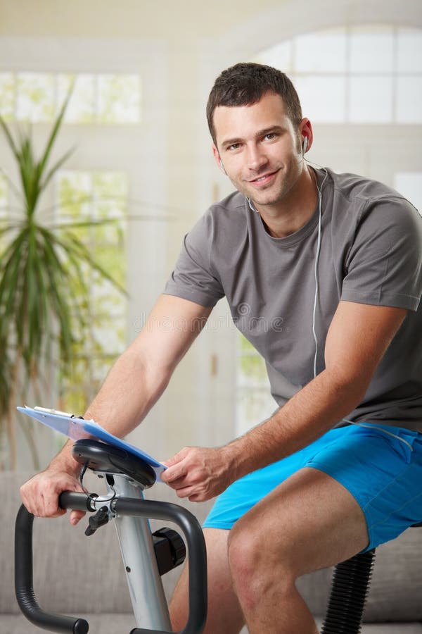 Man Training on Exercise Bike Stock Image - Image of home, caucasian ...