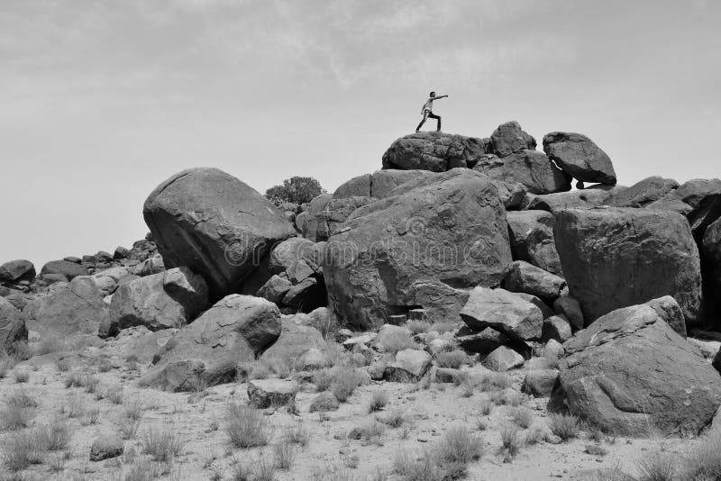 Man Training on Martial Arts on a Pile of Rocks in the Desert #2 -B&W ...