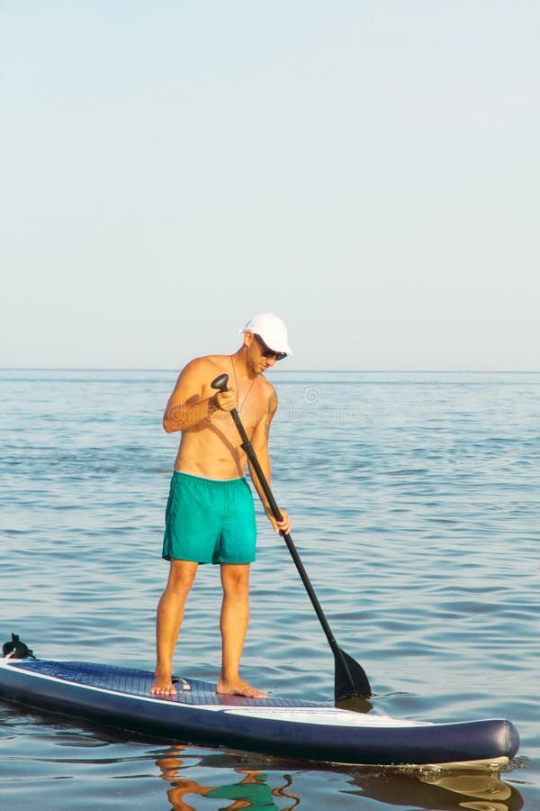 Man is Training on a SUP Board in the Summer Sea Stock Photo - Image of ...