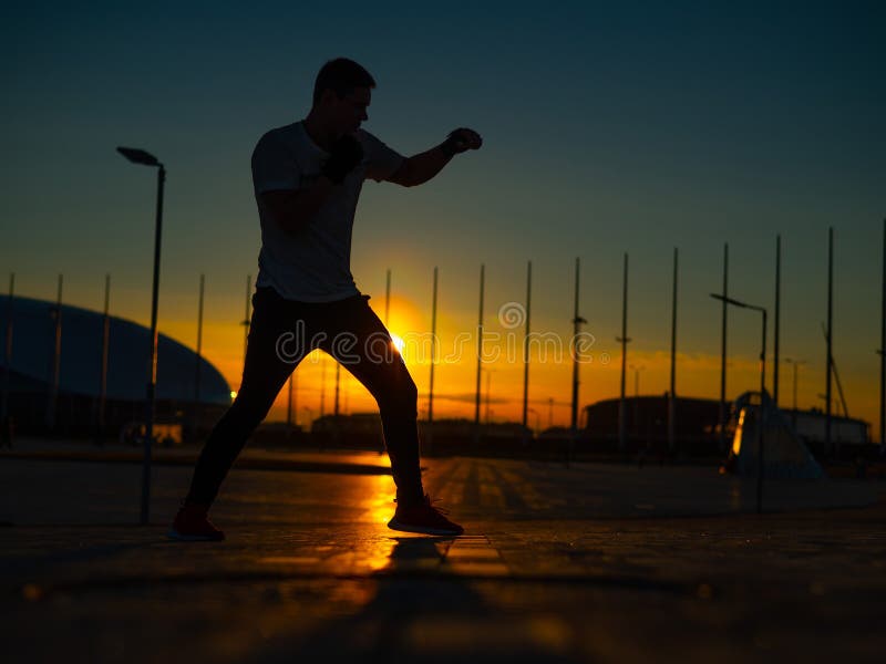 A Man Trains Boxing at Sunset Outdoors. Stock Image - Image of exercise ...