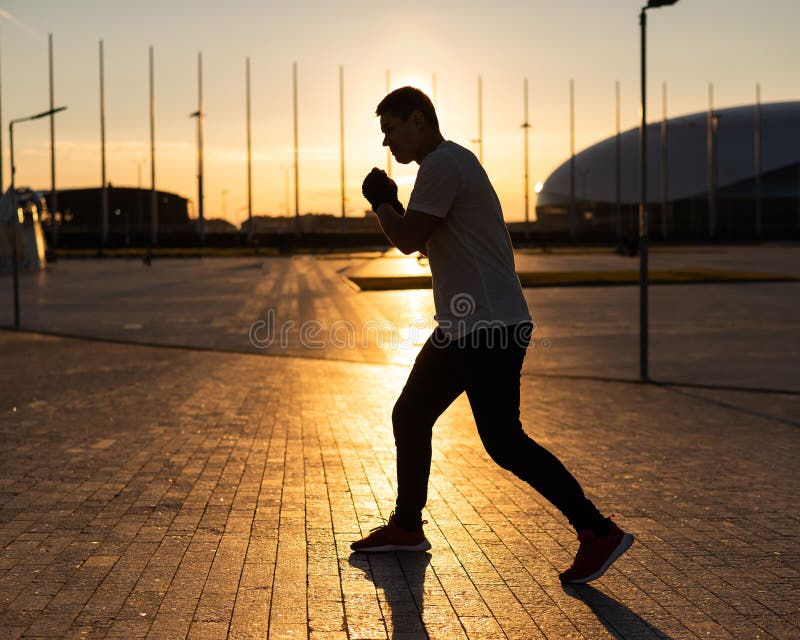 A Man Trains Boxing at Sunset Outdoors. Stock Image - Image of body ...