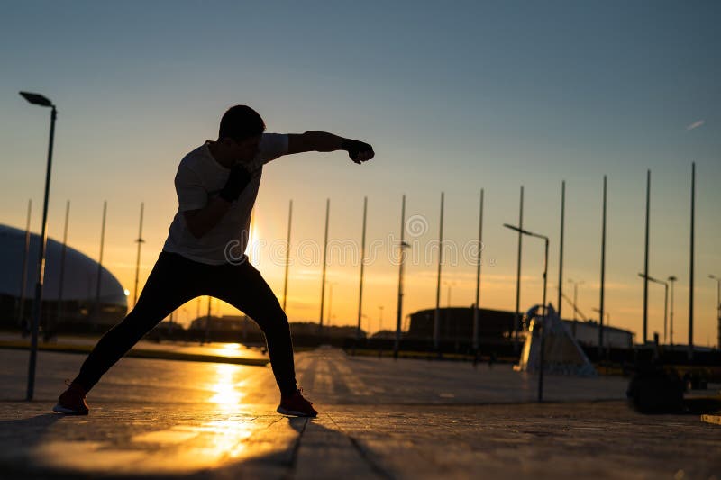 A Man Trains Boxing at Sunset Outdoors. Stock Image - Image of training ...
