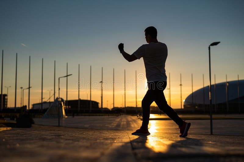 A Man Trains Boxing at Sunset Outdoors. Stock Photo - Image of ...