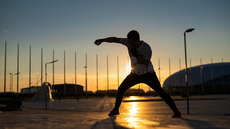 A Man Trains Boxing at Sunset Outdoors. Stock Photo - Image of hitting ...