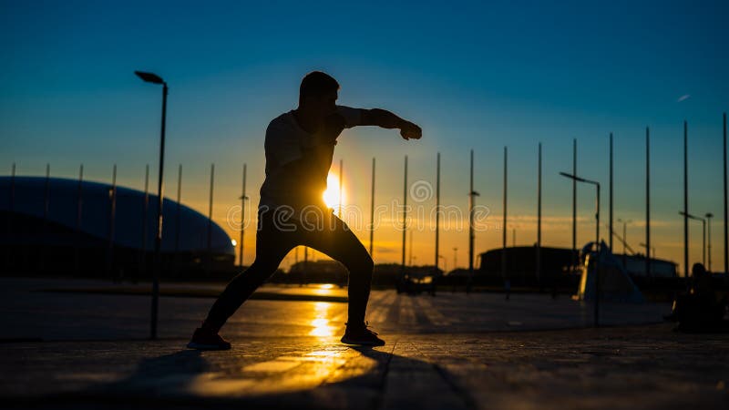A Man Trains Boxing at Sunset Outdoors. Stock Photo - Image of intense ...