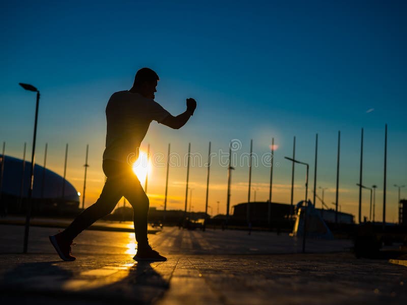 A Man Trains Boxing at Sunset Outdoors. Stock Image - Image of ...