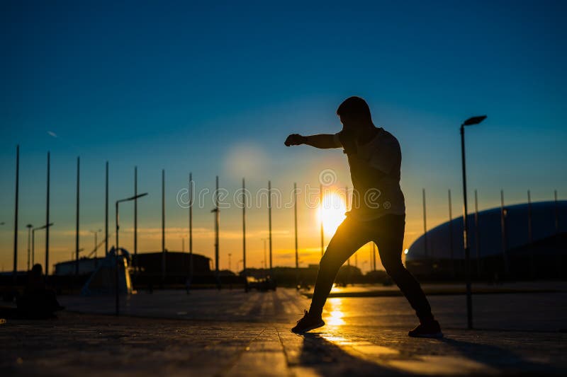 A Man Trains Boxing at Sunset Outdoors. Stock Photo - Image of cardio ...